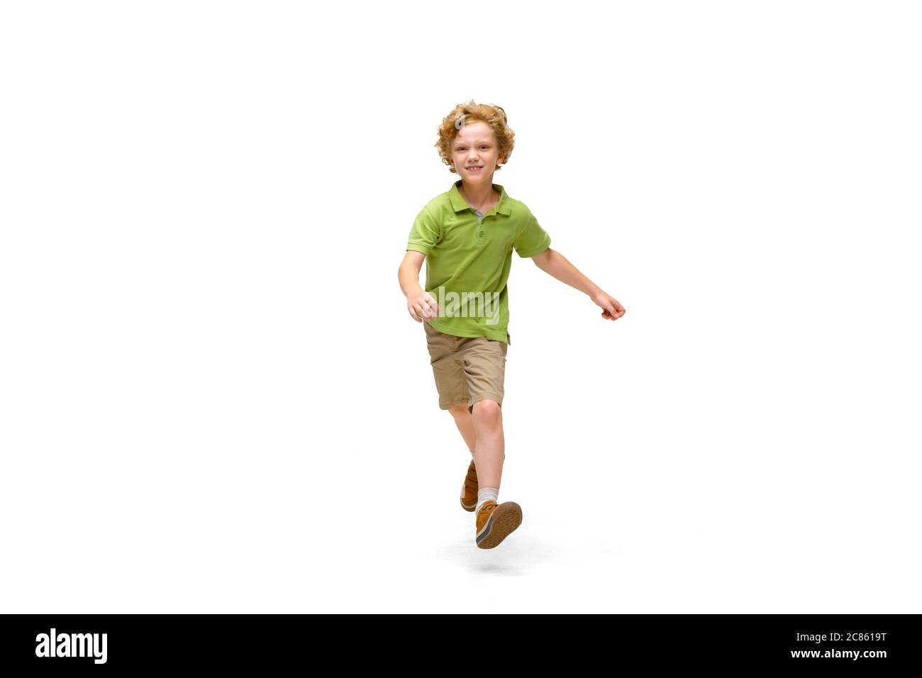 Happy child, little and emotional caucasian boy jumping and running ...