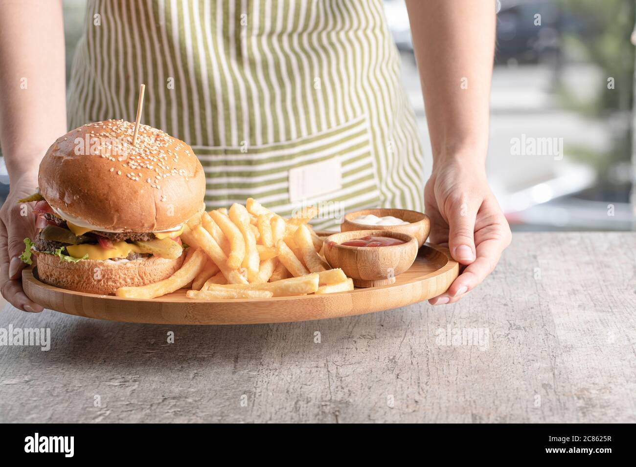 A hostess serving fast food menu Stock Photo - Alamy