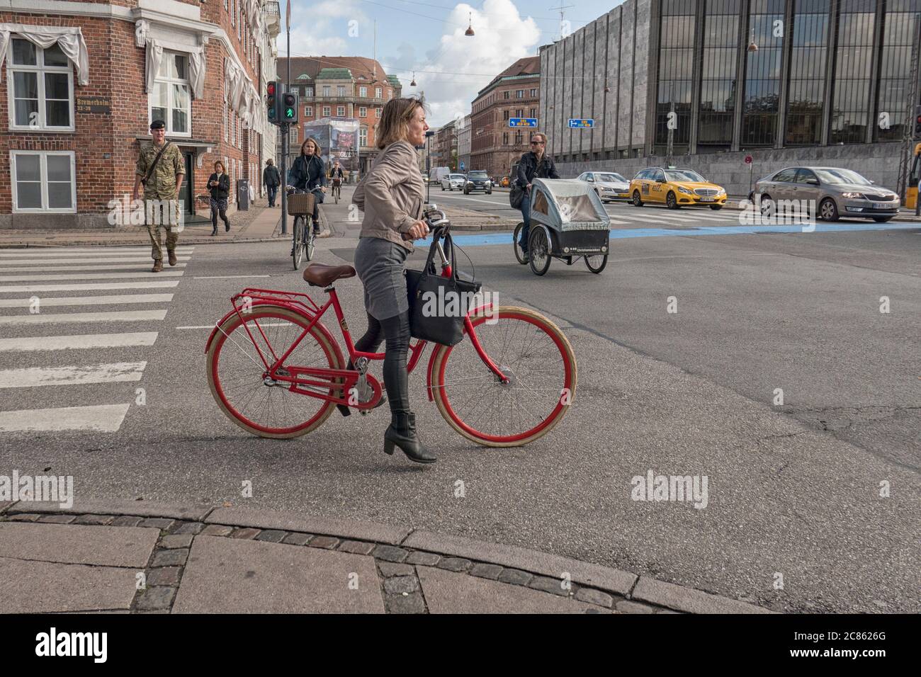 People on bikes and walking on the street in Copenhagen, Denmark Stock ...