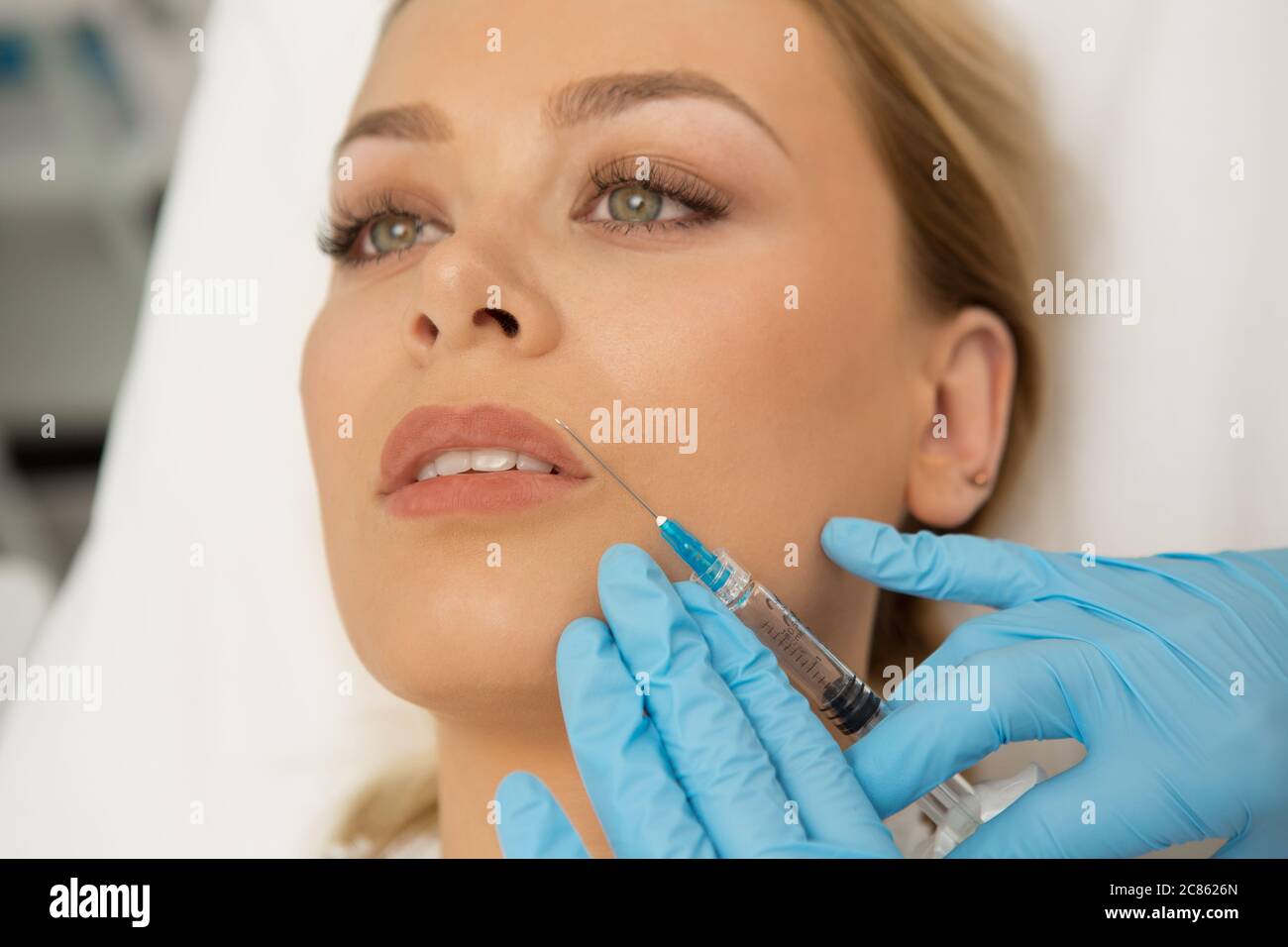 Close up of a gorgeous woman getting facial treatment at beauty clinic ...