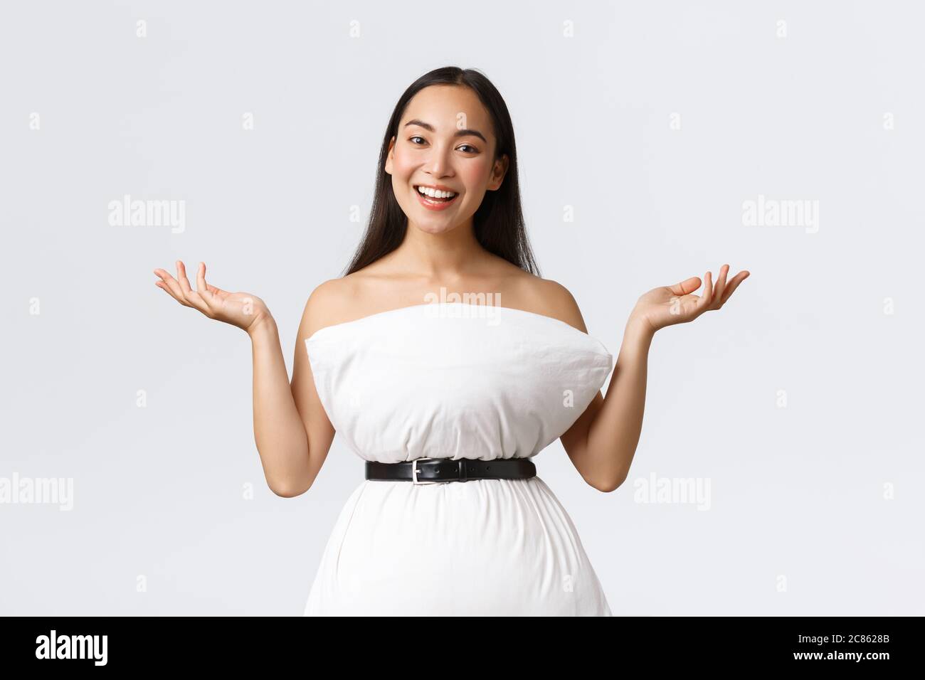 Gorgeous smiling and creative asian woman create dress from pillow ...
