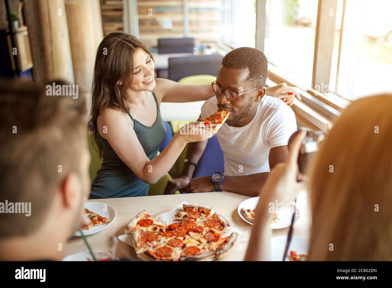 Young Multiracial Diverse Colleagues Eating Pizza During Their Lunch