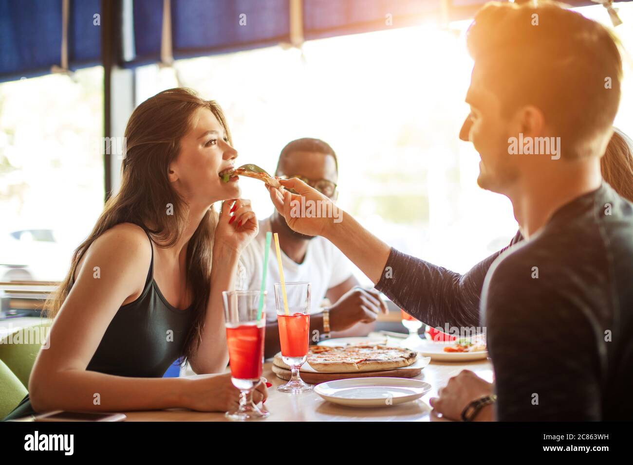 Young Multiracial Diverse Colleagues Eating Pizza During Their Lunch