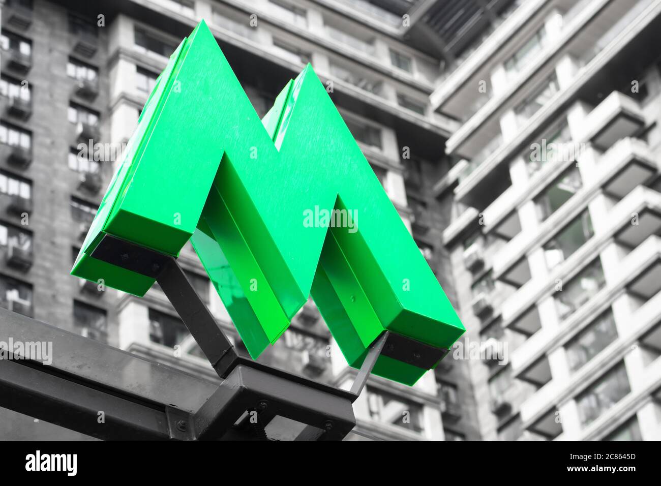KYIV, UKRAINE - JULY 04, 2020: Green metro sign and modern building as ...