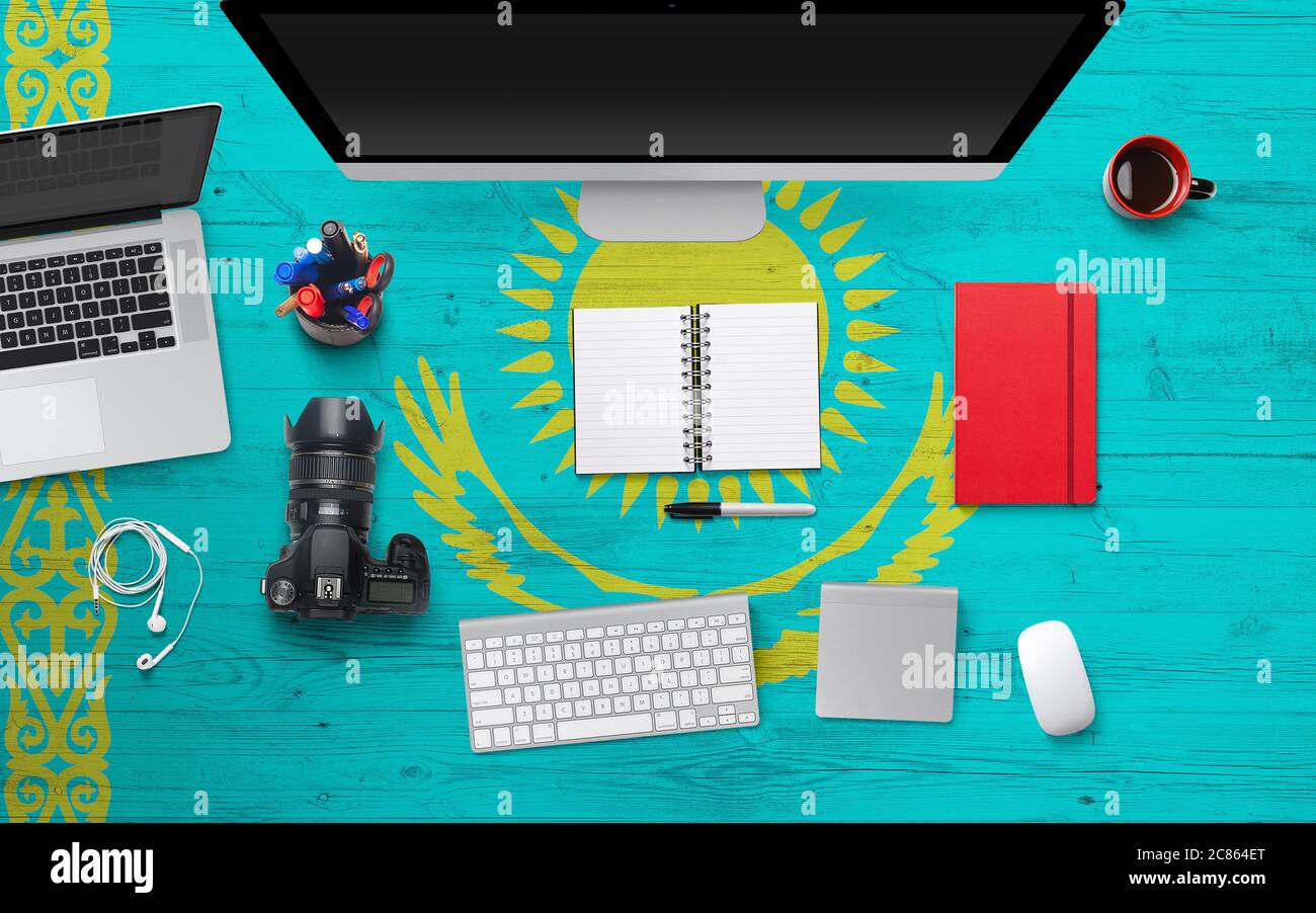 Kazakhstan flag background with headphone,camera, notebook and mouse on ...