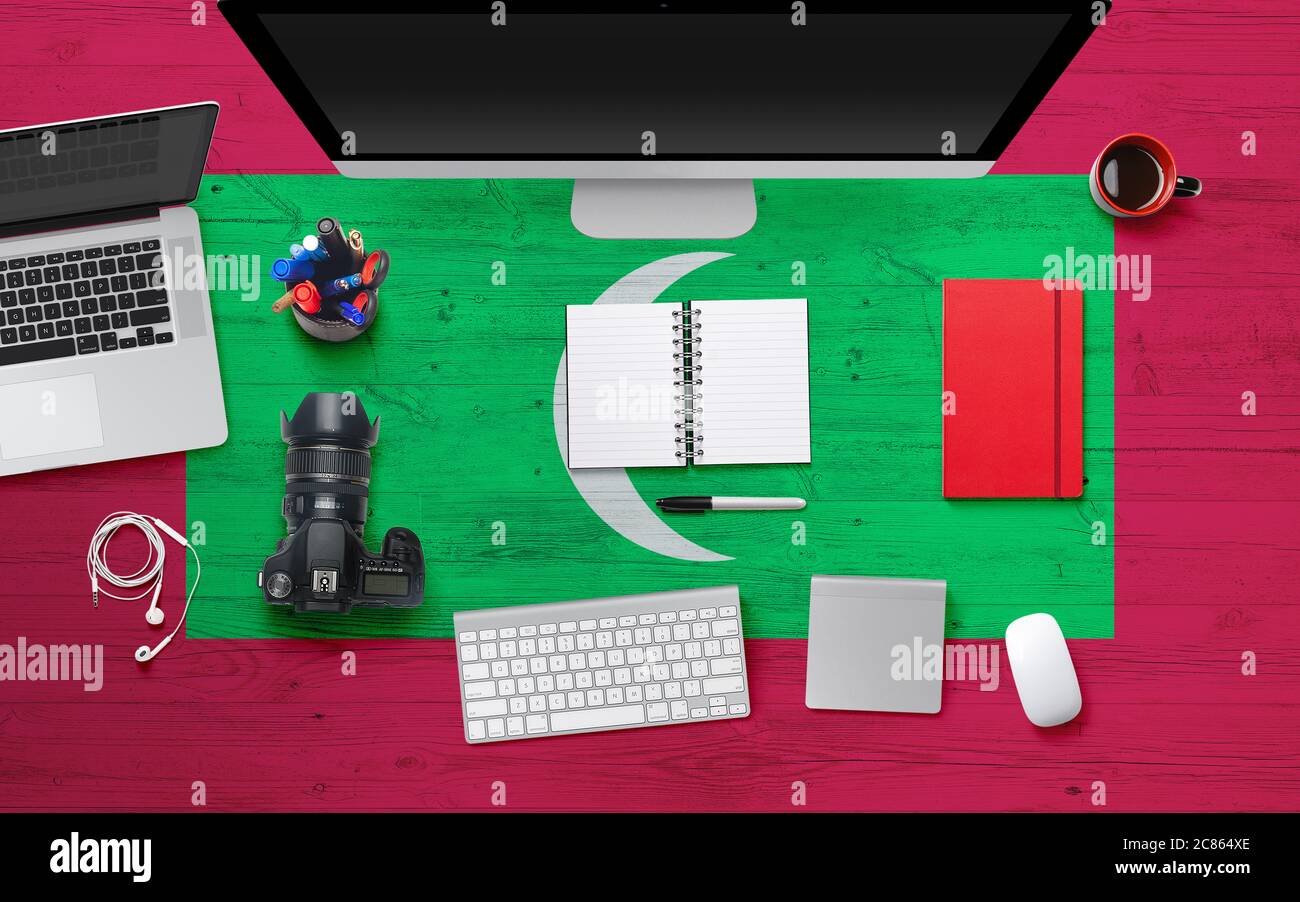 Maldives flag background with headphone,camera, notebook and mouse on ...