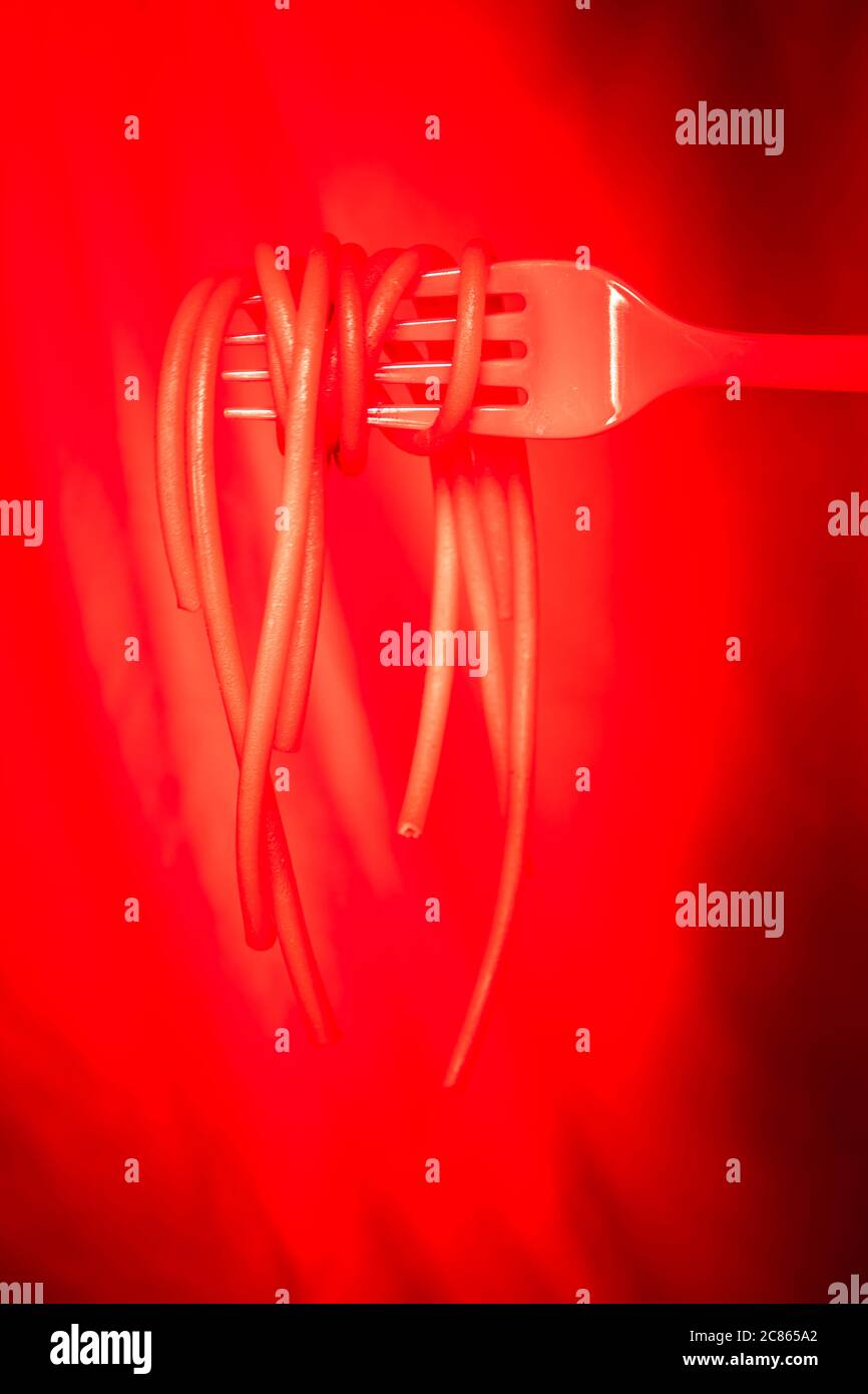 Spaghetti new defined. Hot red spaghetti on a red fork on black ...