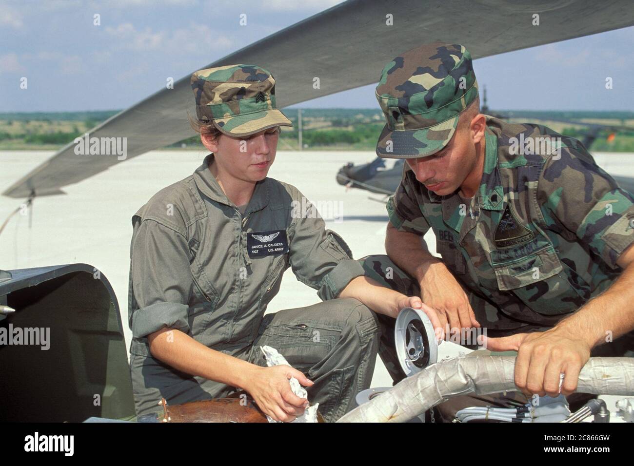 Female U.S. Army aviation mechanic working with male colleague on ...