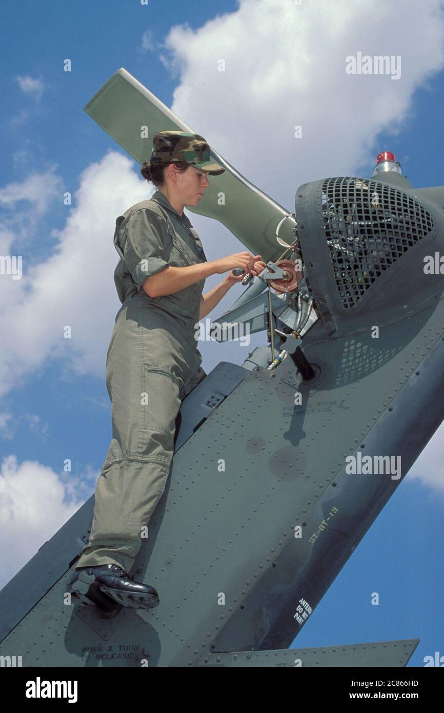 Female U.S. Army aviation mechanic working on military plane. ©Bob ...
