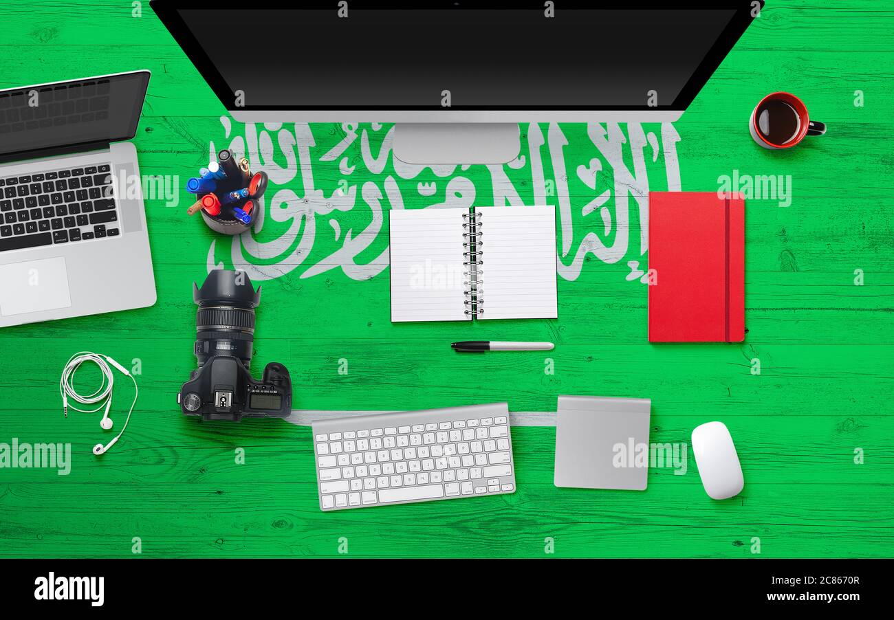 Saudi Arabia flag background with headphone,camera, notebook and mouse ...