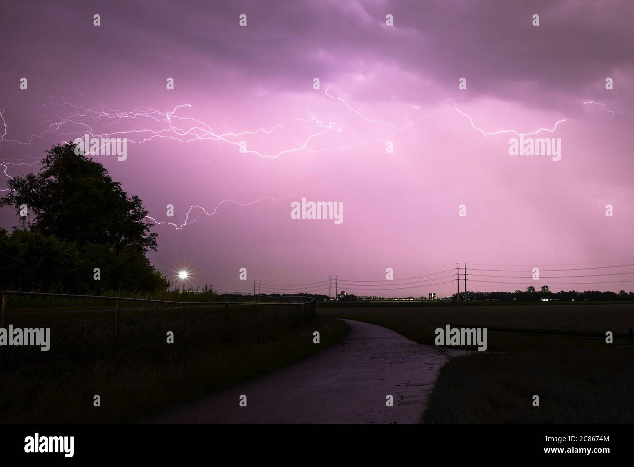 Lightning above power lines during a severe thunderstorm Stock Photo ...