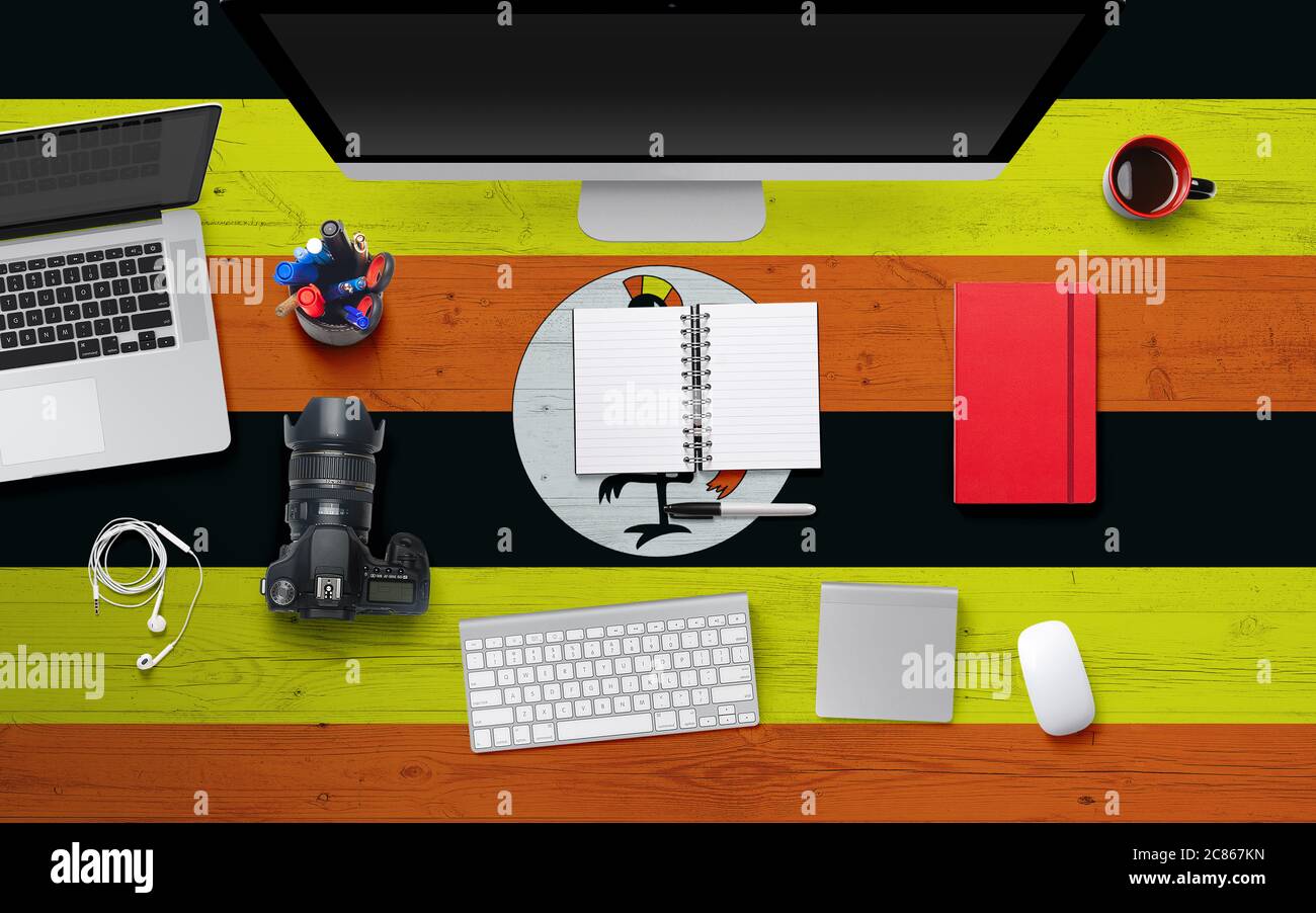Uganda flag background with headphone,camera, notebook and mouse on ...