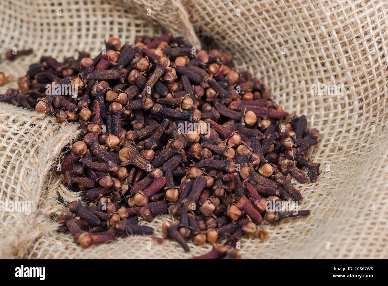 Dried cloves on sack background Stock Photo - Alamy
