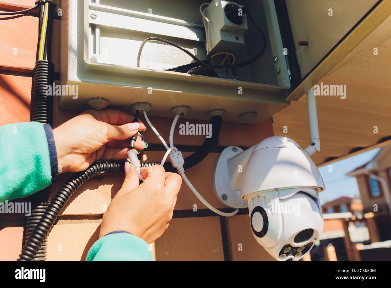 technician female setup cctv camera on wall Stock Photo - Alamy