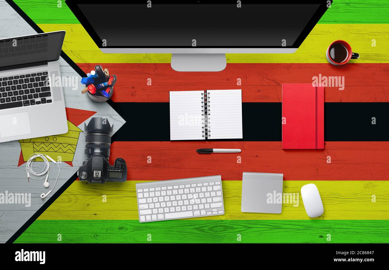Zimbabwe flag background with headphone,camera, notebook and mouse on ...