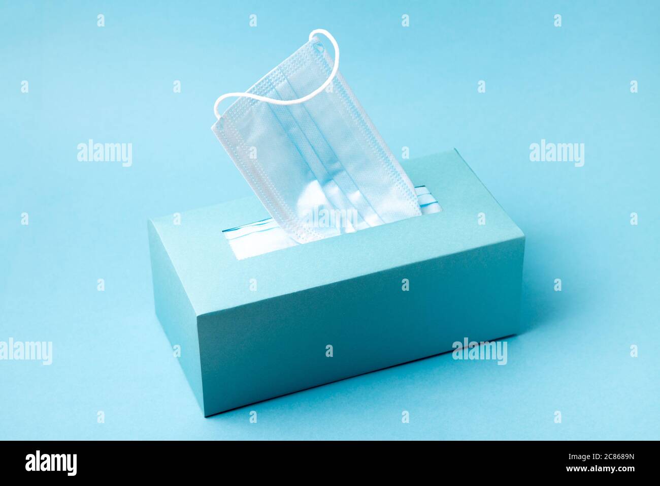 Disposable blue face mask box on blue background. Minimal monochromatic ...