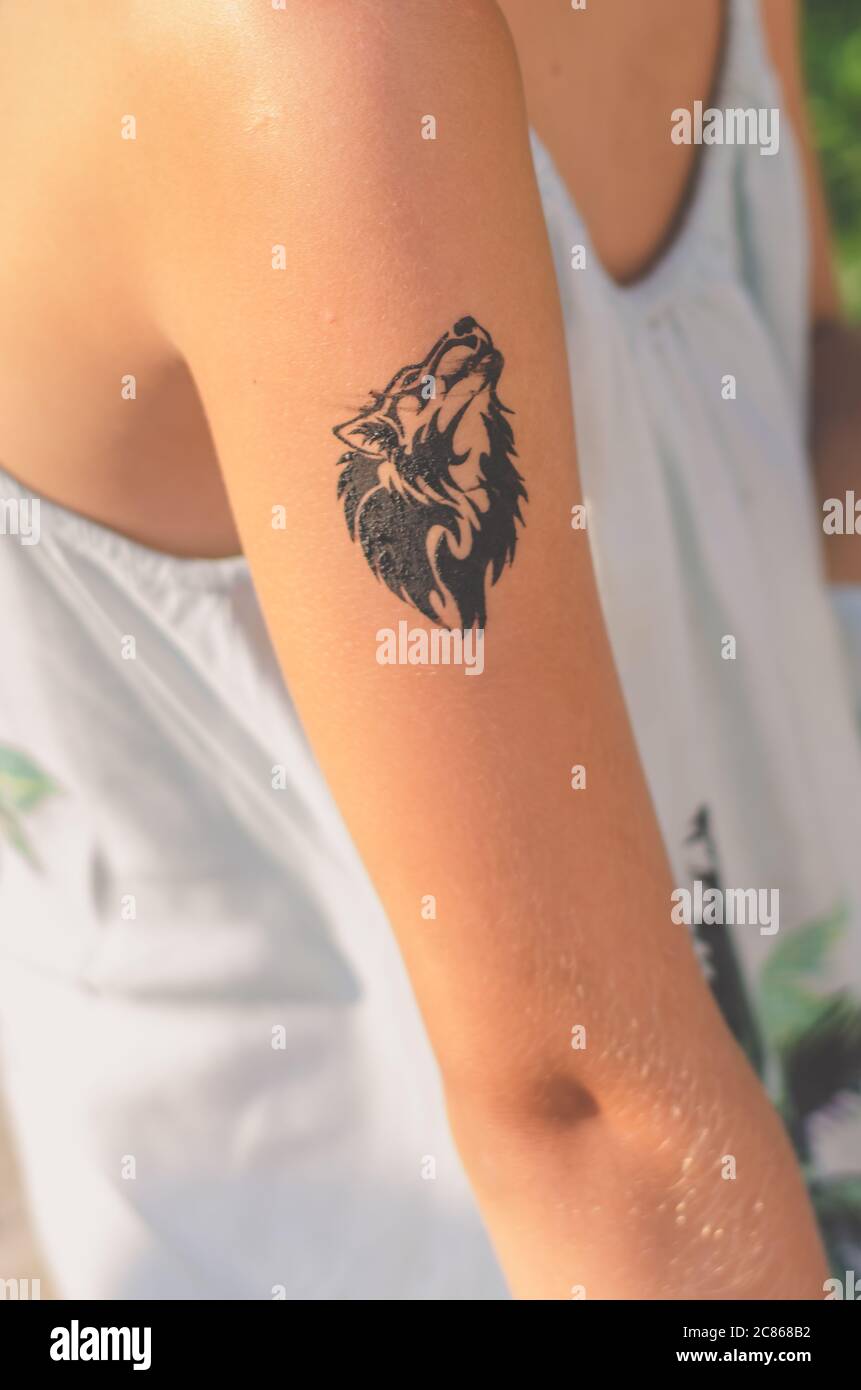 little girl with black henna tattoo of wolf in the shoulder Stock Photo ...