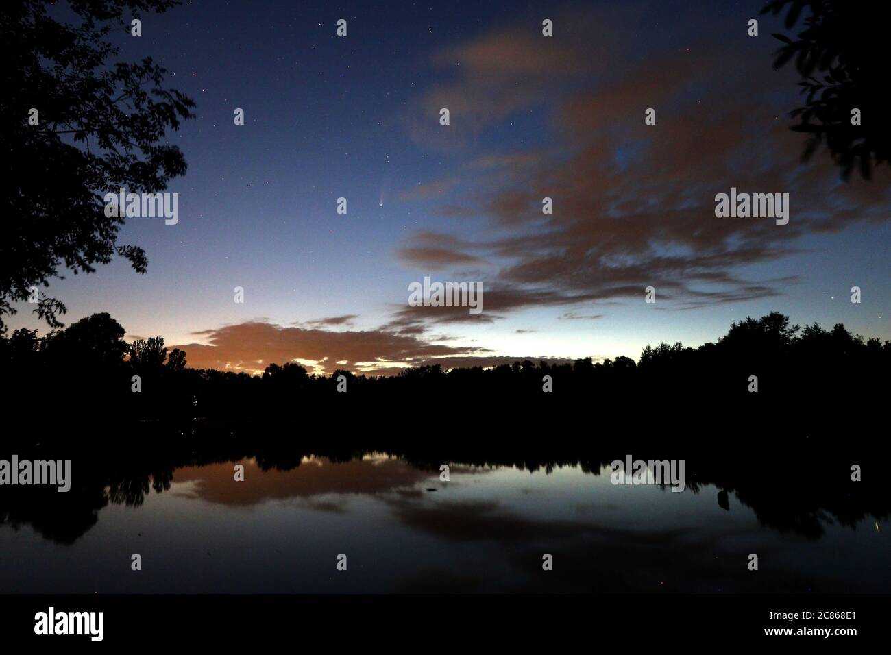 The night sky over Needham Lake in Suffolk showing Comet NEOWISE Stock ...