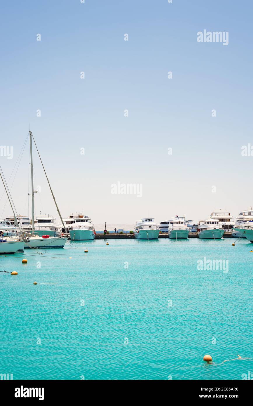 Modern high-speed boats and yachts parked near pierce on a turquoise ...