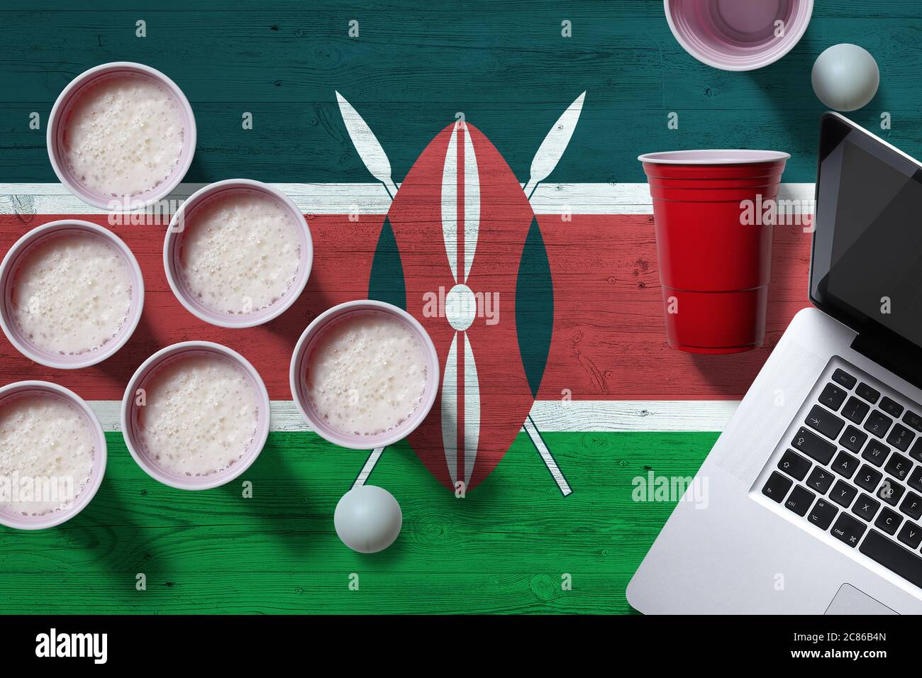 Kenya flag concept with plastic beer pong cups and laptop on national ...