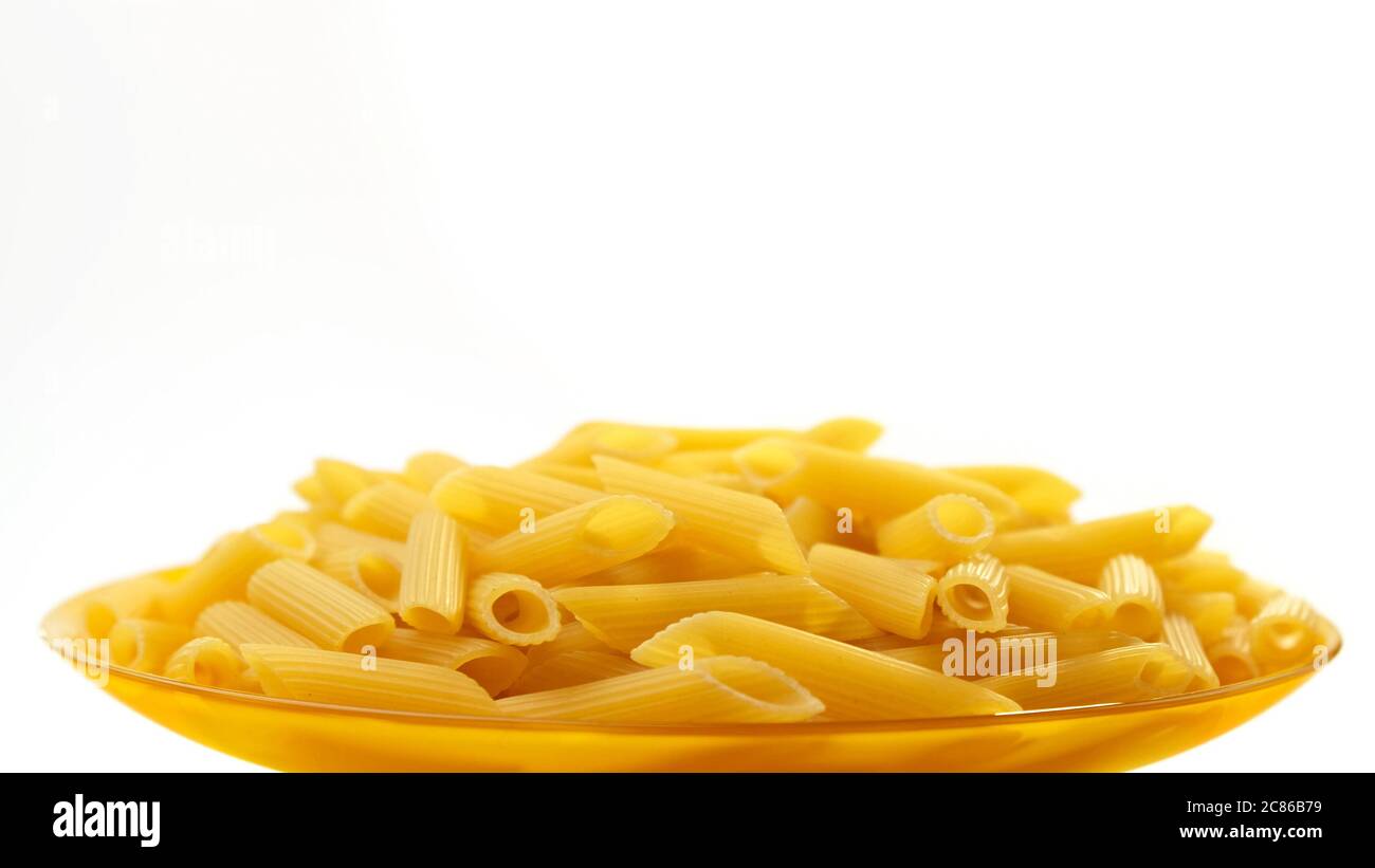 Raw italian penne rigate pasta on white background Stock Photo - Alamy