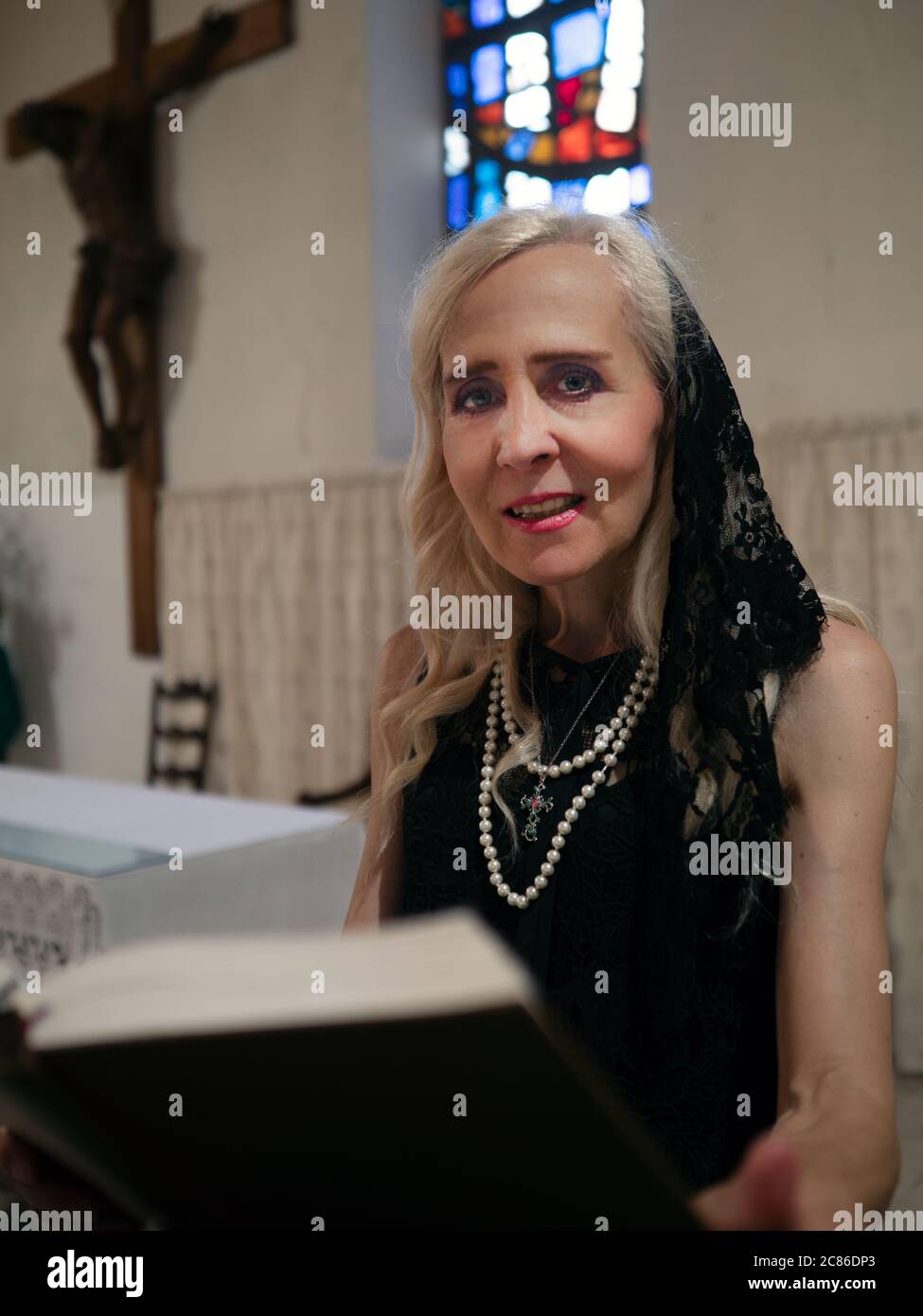 Horizontal Portrait Of A Smiling Mature Woman Reading The Holy Bible In