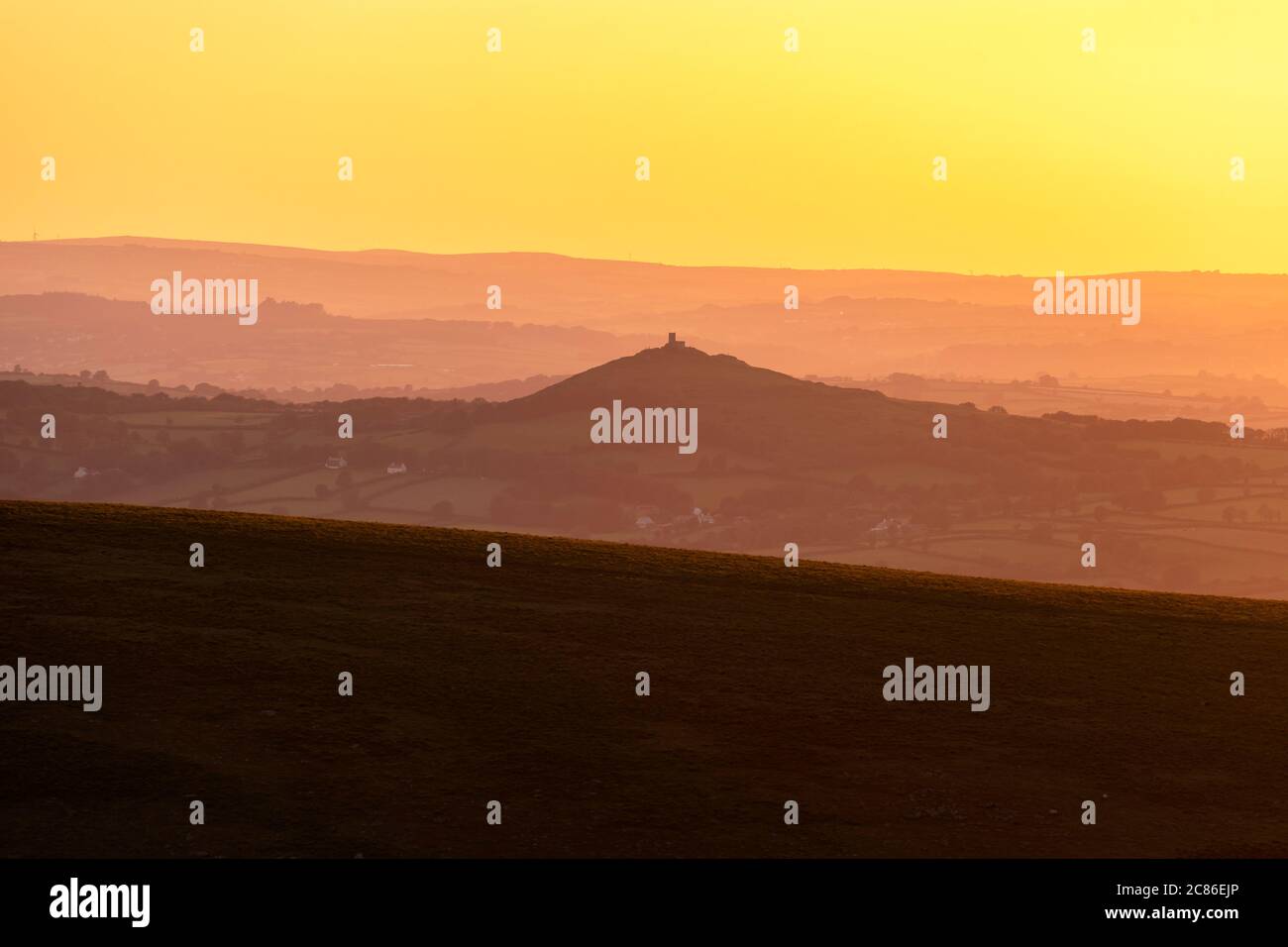 Sunset layers in the landscape with views to Brentor church on Dartmoor ...