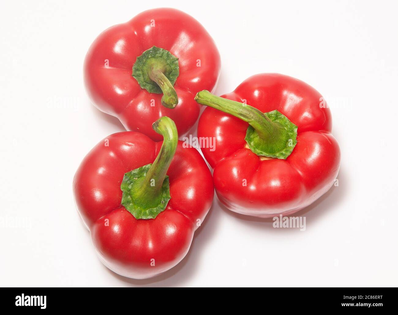 three red paprikas closeup on white background Stock Photo - Alamy