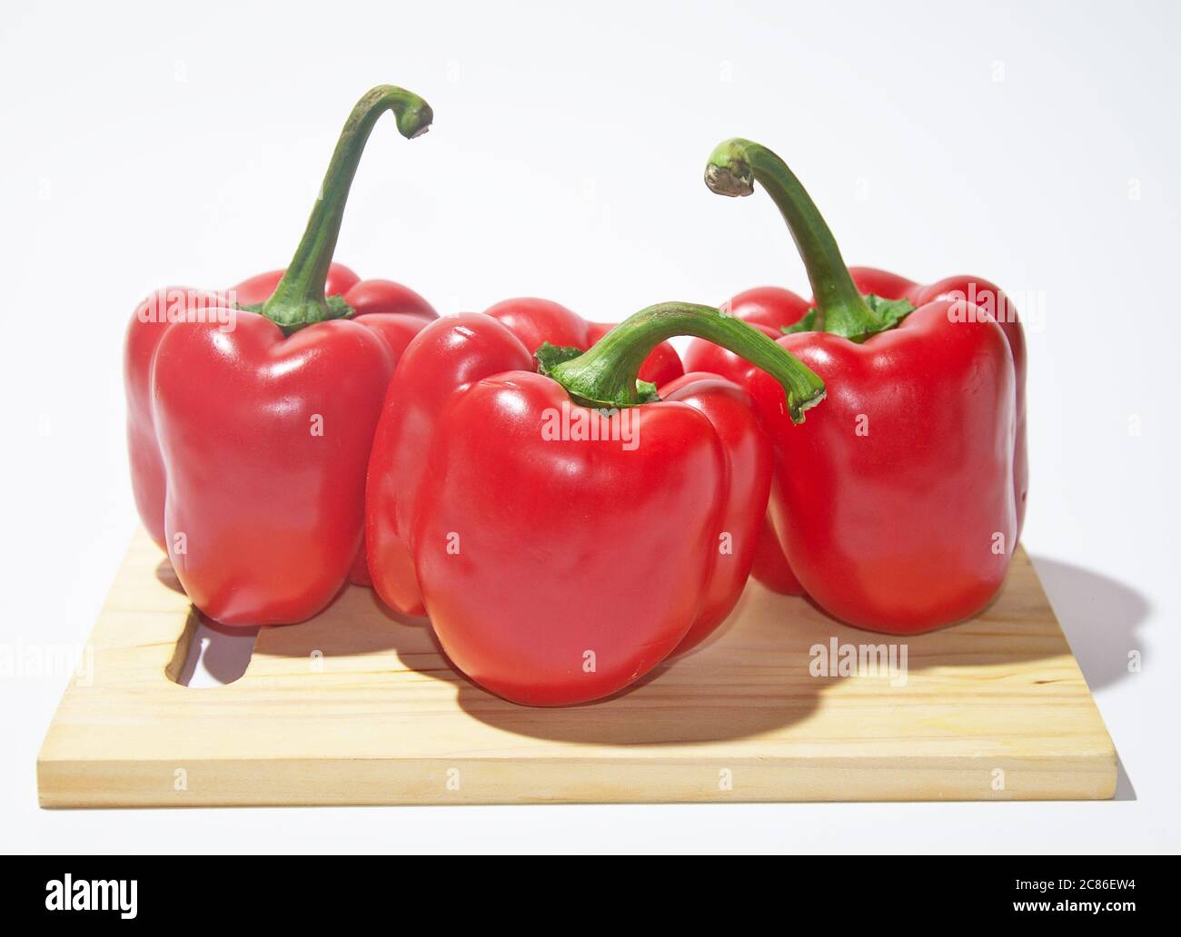 three red paprikas closeup on white background Stock Photo - Alamy