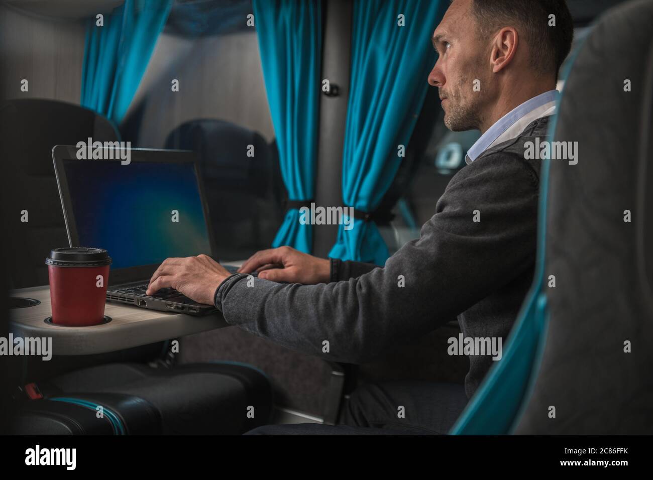 Wireless Remote Work on the Road. Businessman Working on His Laptop ...