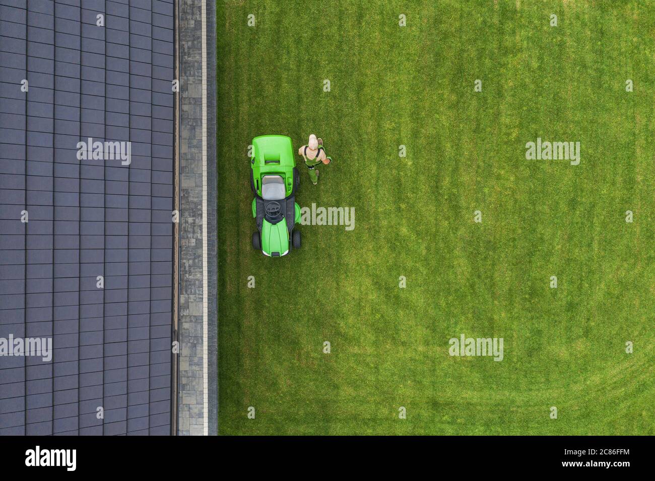 Landscaping Work. Aerial View of Modern Green Riding Lawn Mower and ...