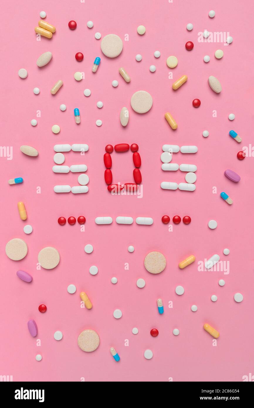 SOS morse code with medical drugs and pills, top view flat lay ...
