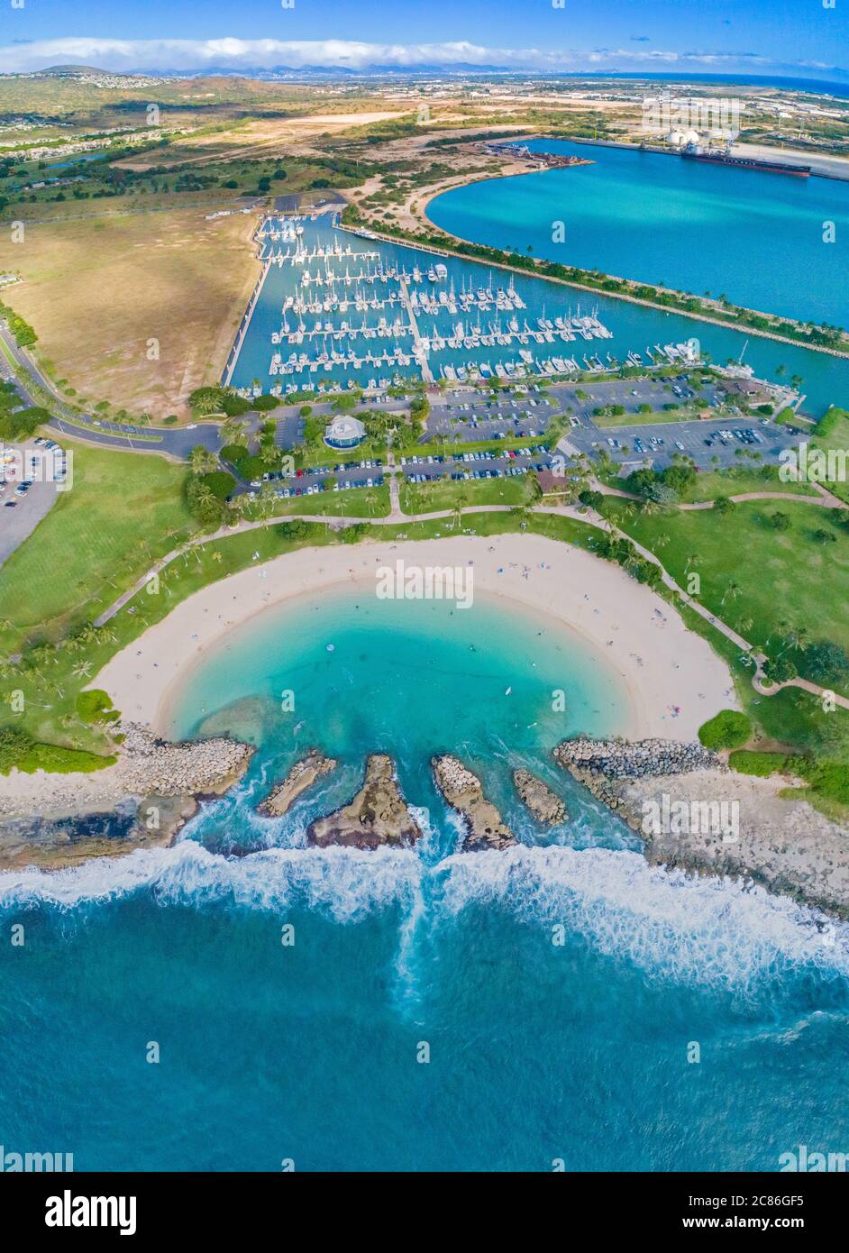 An aerial view of Ko Olina lagoon #4 and beach, Barbers Point Harbor ...
