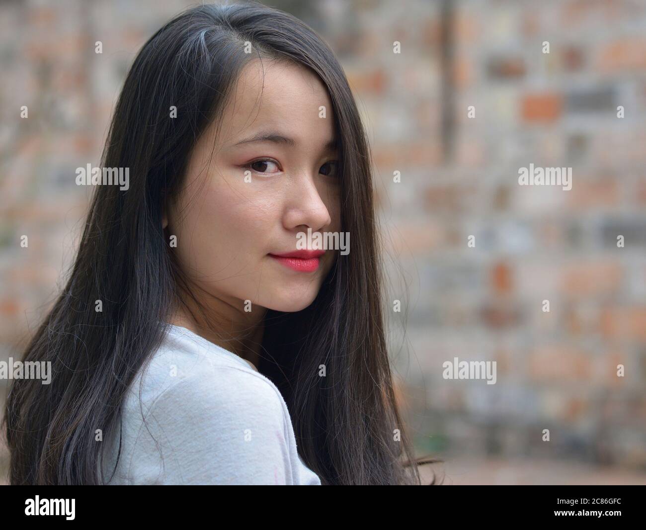 Pretty Vietnamese girl with long hair poses for the camera Stock Photo ...