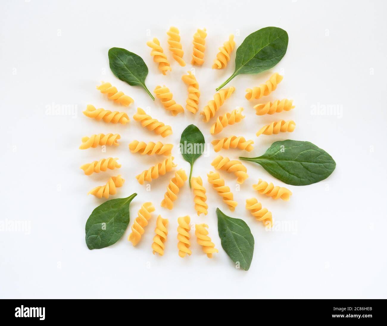 Twisted raw pasta and spinach food knolling circle shape white ...