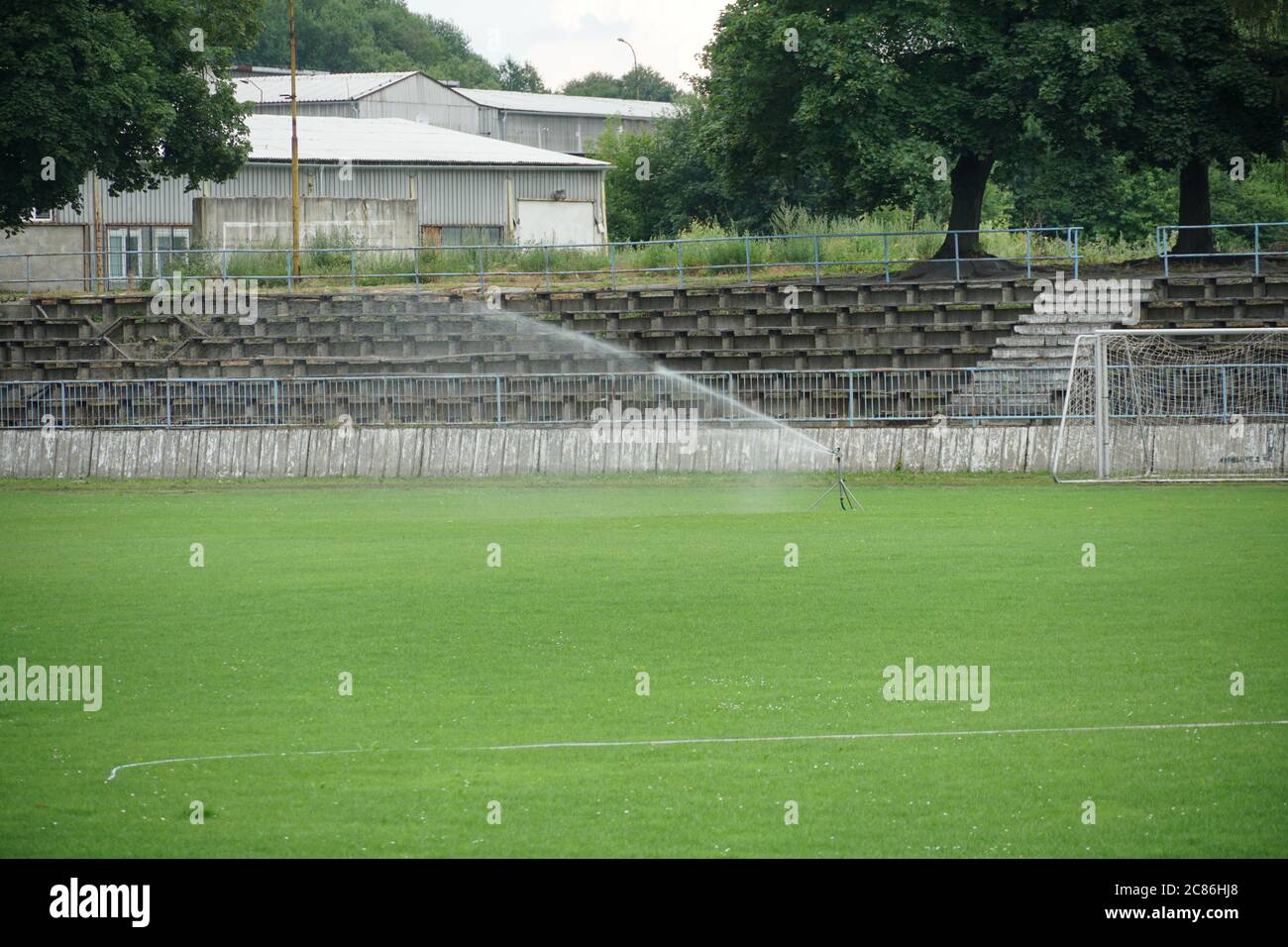 old football stadium with a tribune with decayed wooden seats or banks ...