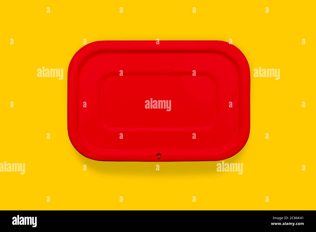Red food container on an orange background. Color-coded packaging for ...