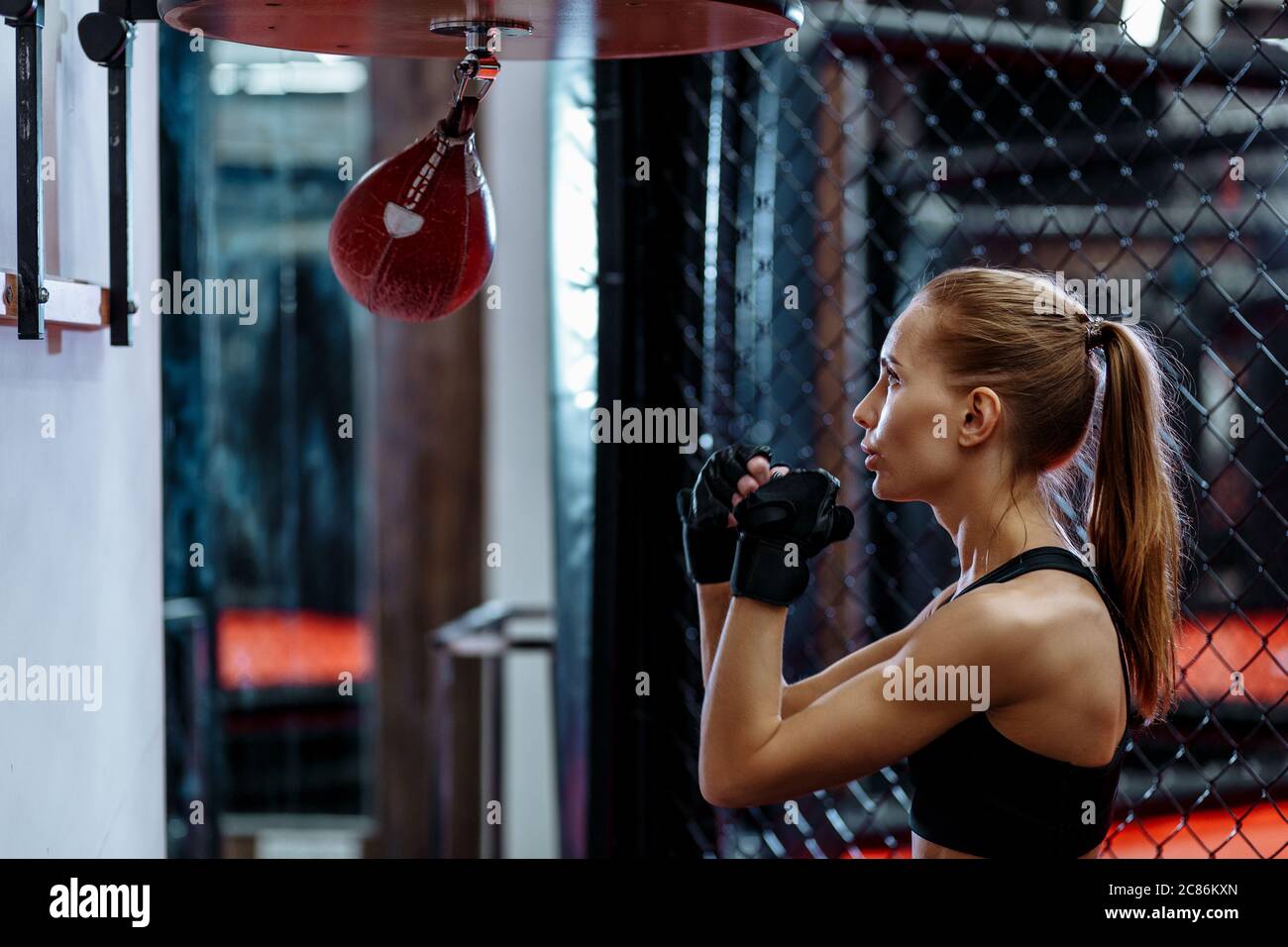 Young blond women boxing, hitting small boxing bag Stock Photo - Alamy