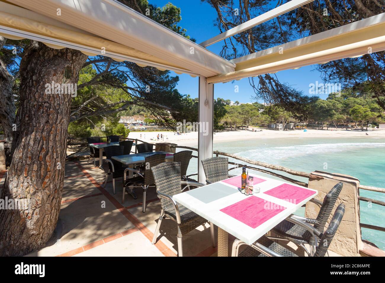 Waterfront restaurant with beach views at Cala Galdana, Menorca Stock ...