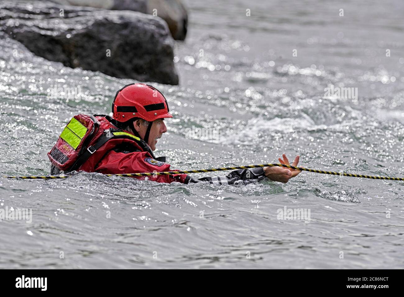 Team member of the Calgary Fire Department Rescue Squad practicing river recovery techniques on ...