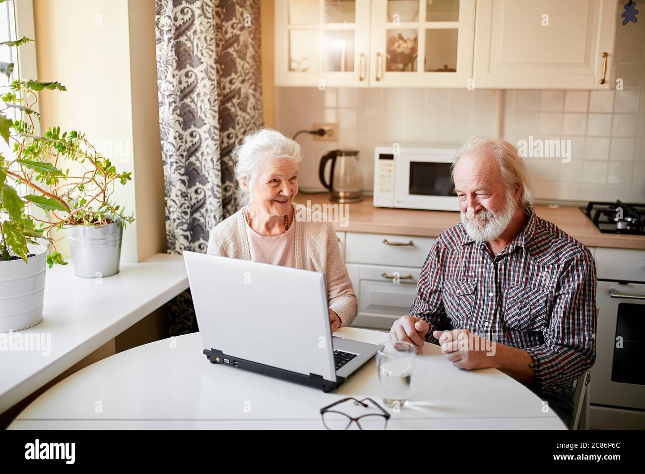 Two elderly retired people spending day at home watching vintage films ...