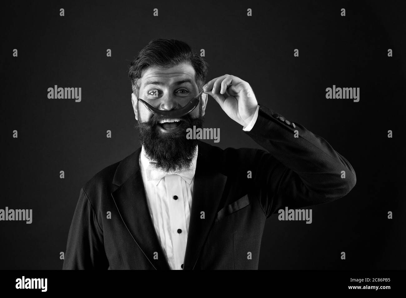 Pepper mustache. Bearded businessman hold chilli red pepper in hand ...