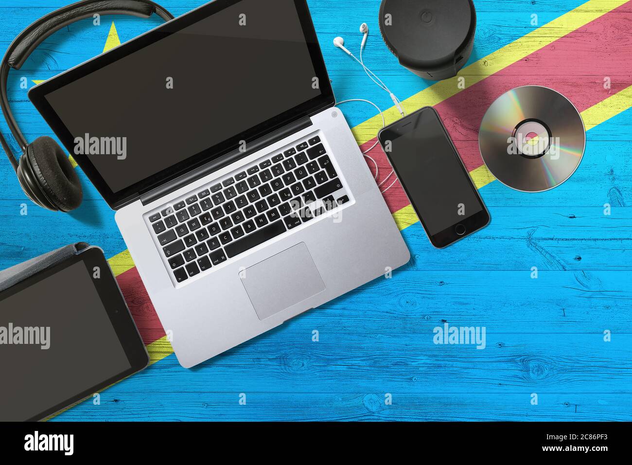 Congo flag on national background wooden table. Portable devices ...