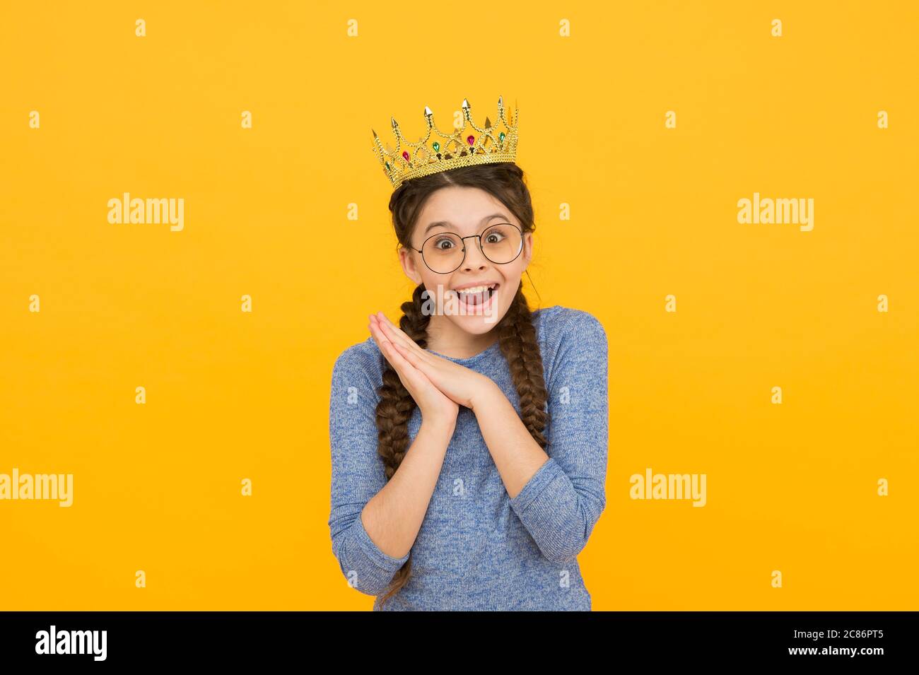 Long awaited reward. Little smart girl wear eyeglasses. Clever child ...