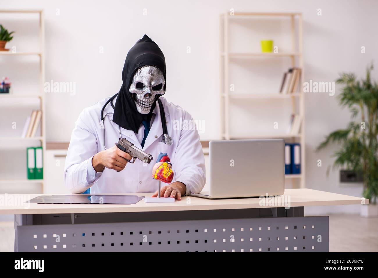 Male devil doctor working in clinic Stock Photo - Alamy