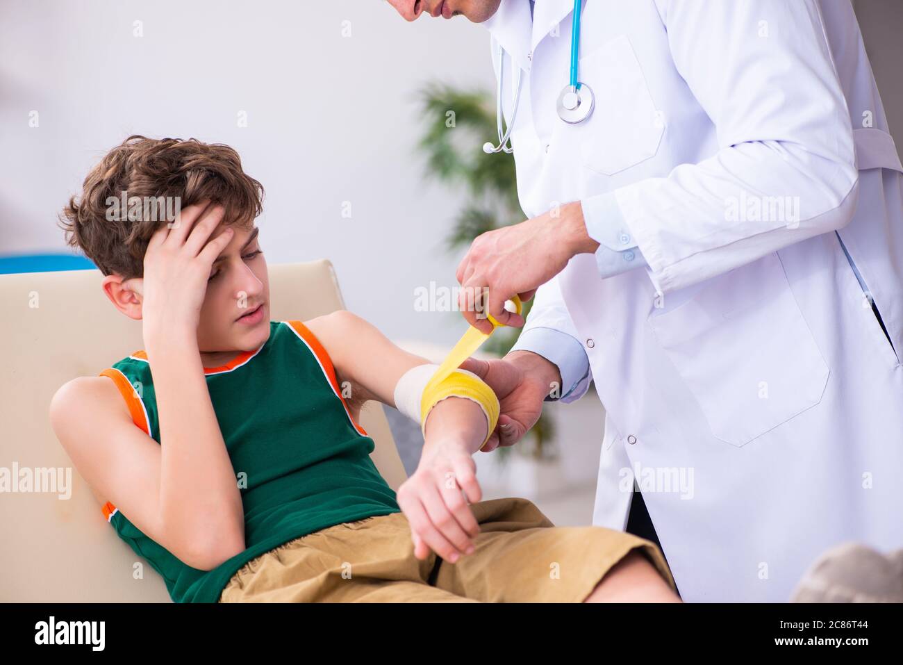 Sick boy visiting young doctor pediatrician Stock Photo - Alamy