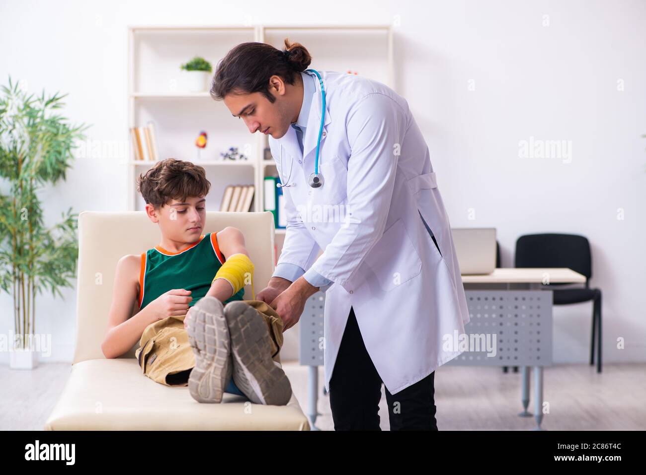 Sick boy visiting young doctor pediatrician Stock Photo - Alamy