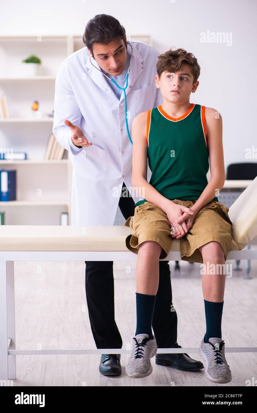 Sick boy visiting young doctor pediatrician Stock Photo - Alamy