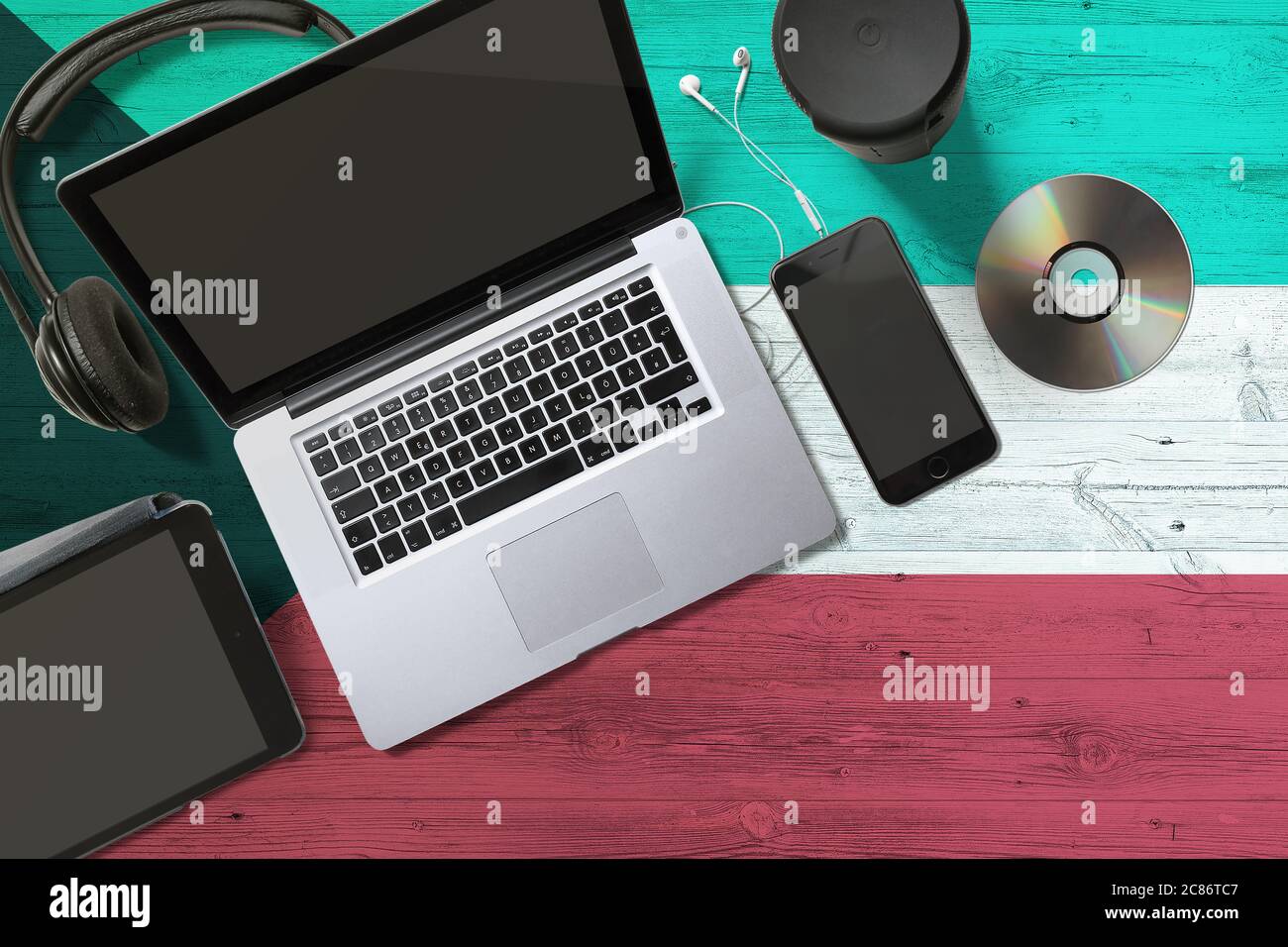 Kuwait flag on national background wooden table. Portable devices ...