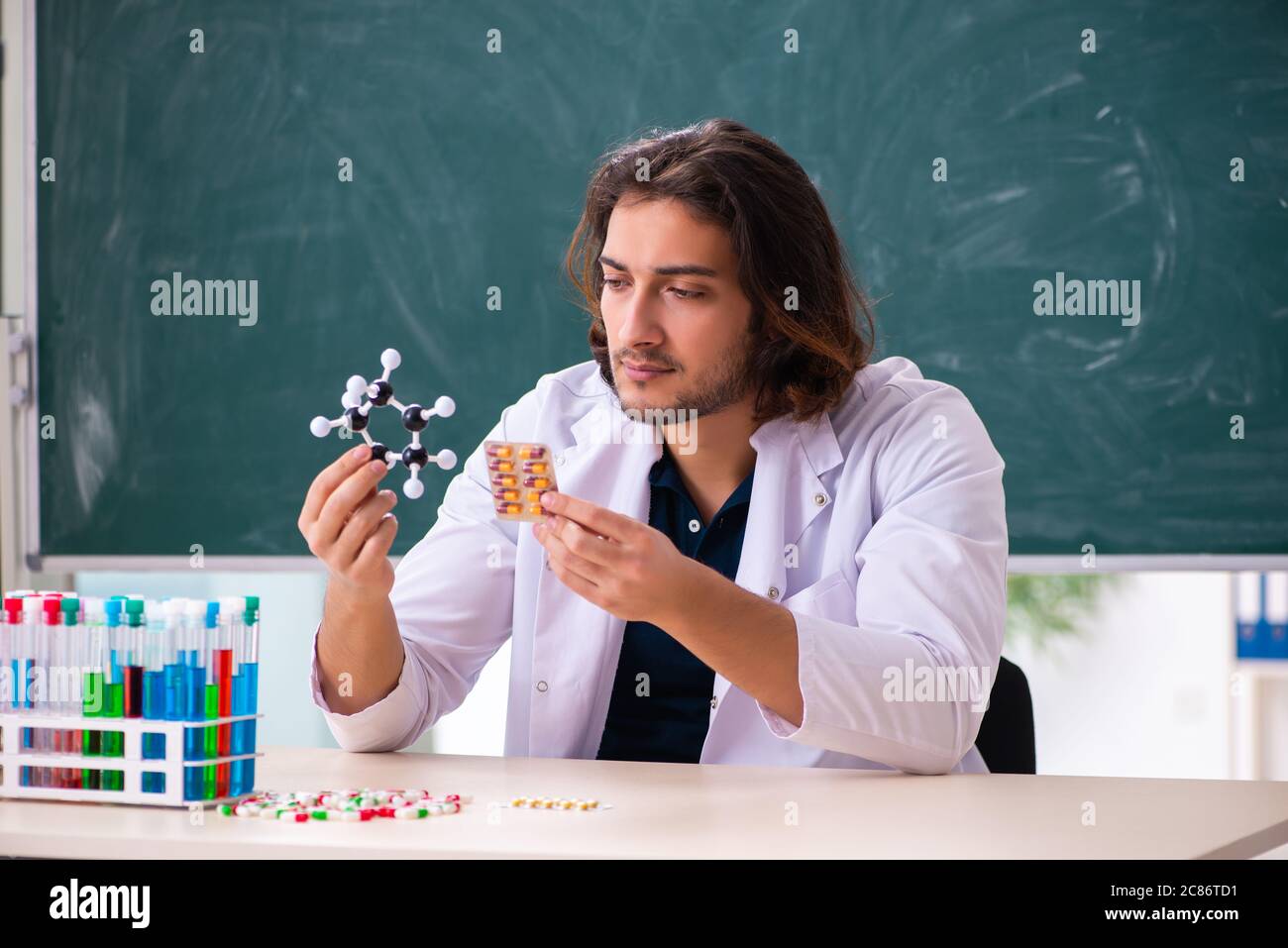 Young scientist sitting in the classroom Stock Photo - Alamy